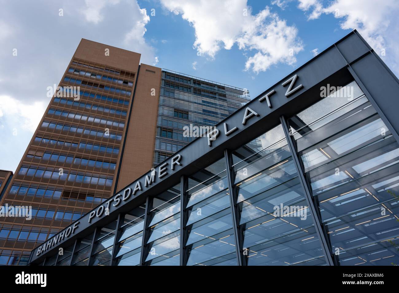 A large building with a glass facade and the inscription Bahnhof ...