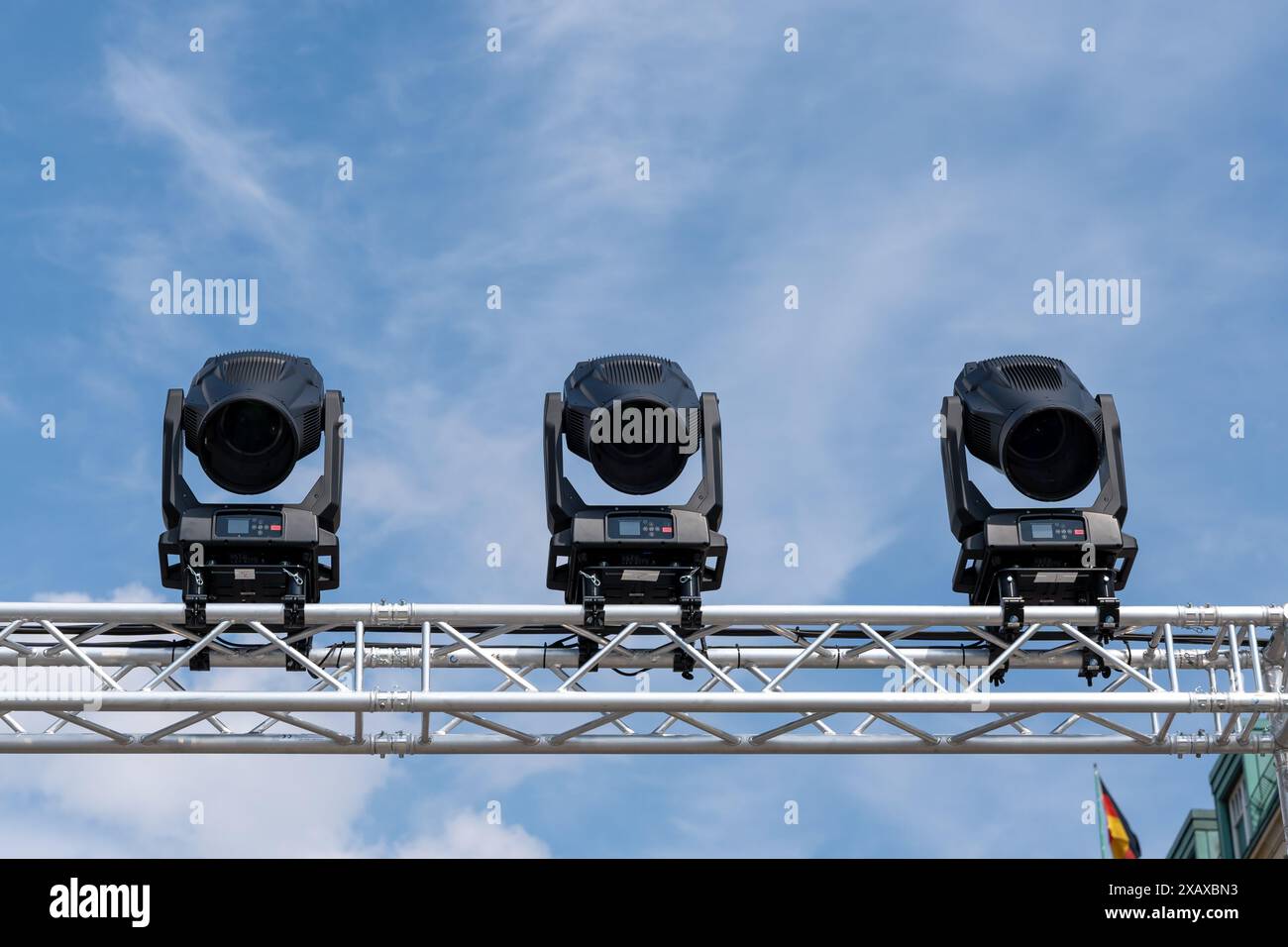 Three lights are mounted on a metal structure, with the top light being ...