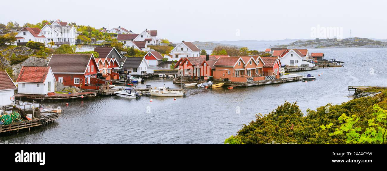 Charming Red and white cottages by the waterfront, with boats docked ...