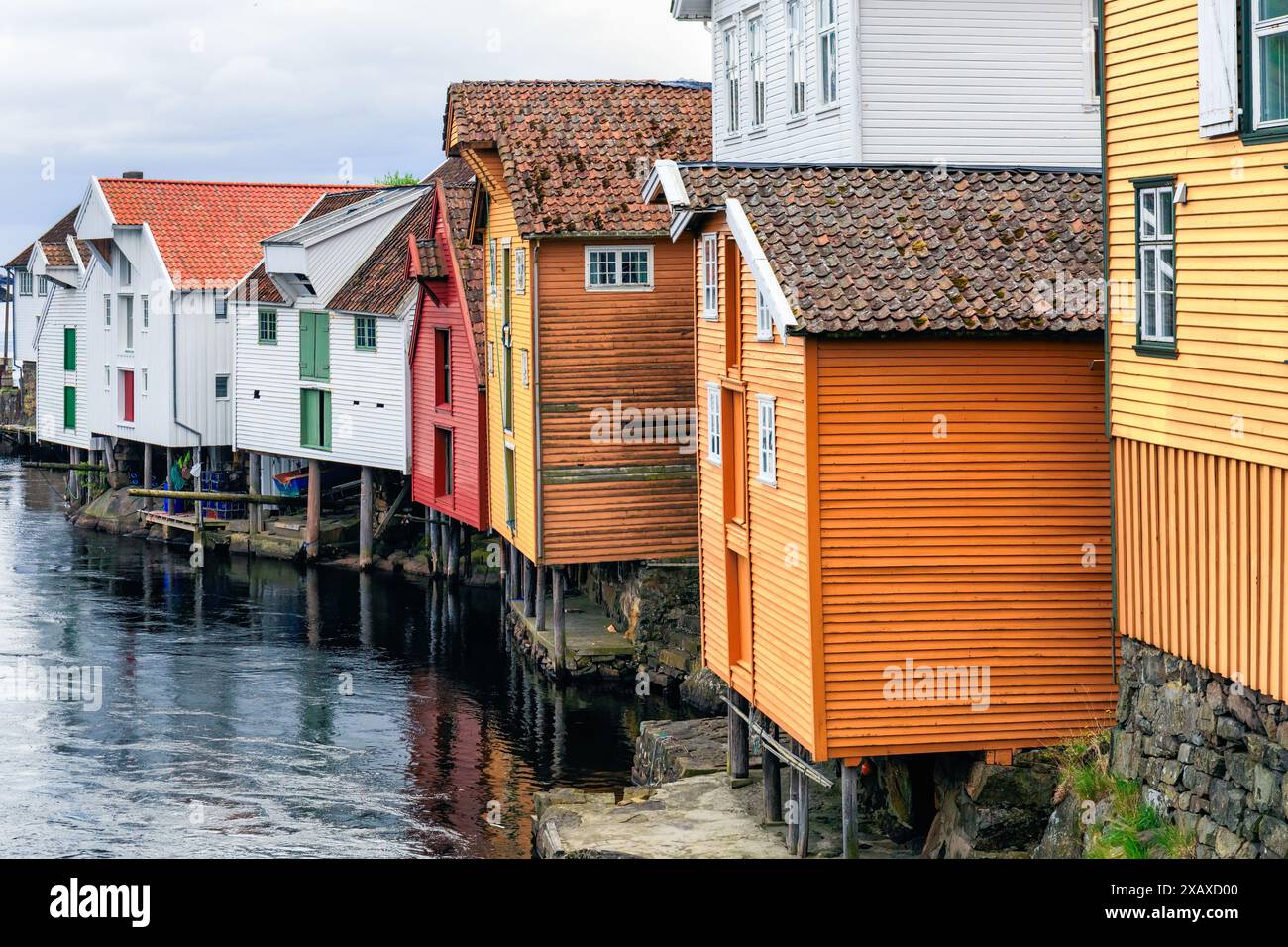 Traditional wooden buildings, painted in vibrant hues, line the river ...