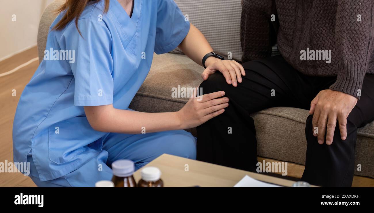 Caregiver Assisting Elderly Patient with Physical Therapy at Home ...