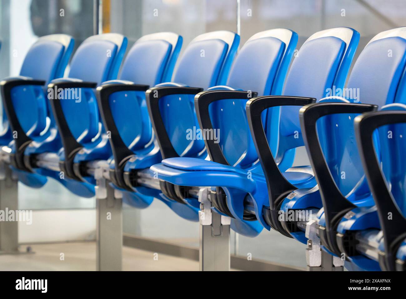 A long row of modern blue chairs with folding seats in a room Stock ...