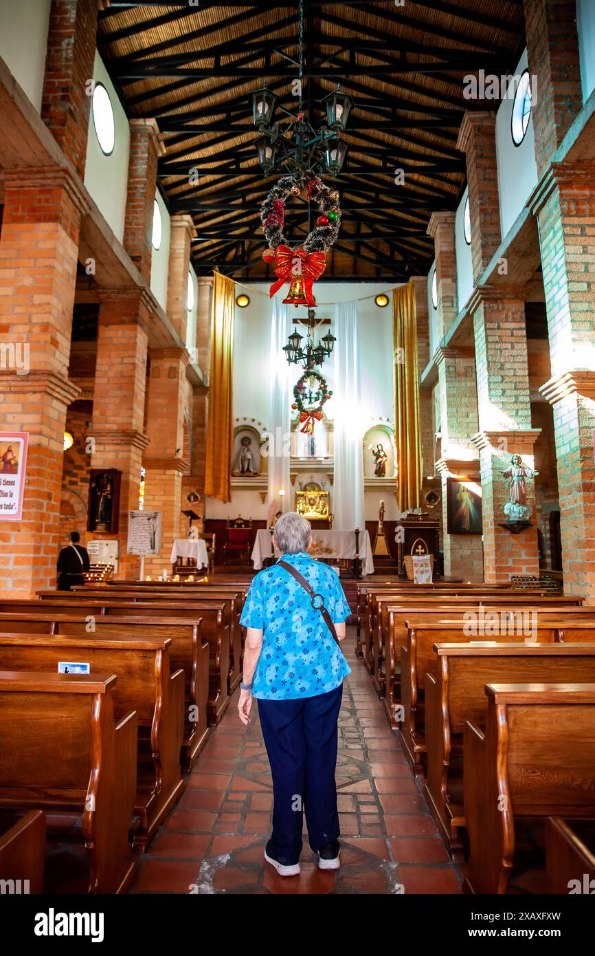 AGUADAS, COLOMBIA - JANUARY 15, 2024: Senior woman praying to the ...