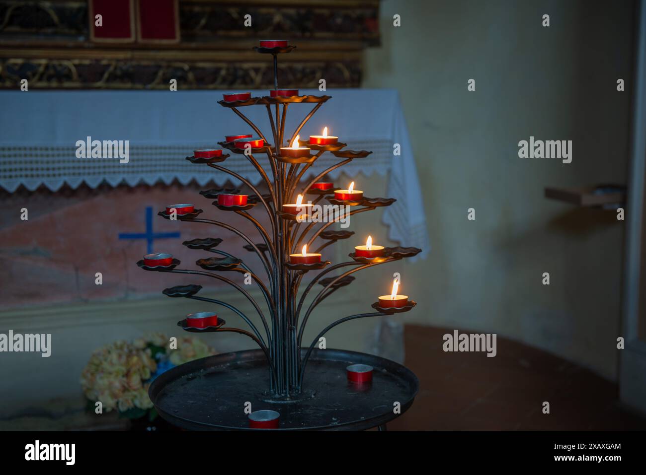 Antique wrought iron candelabra with lit candles Stock Photo - Alamy