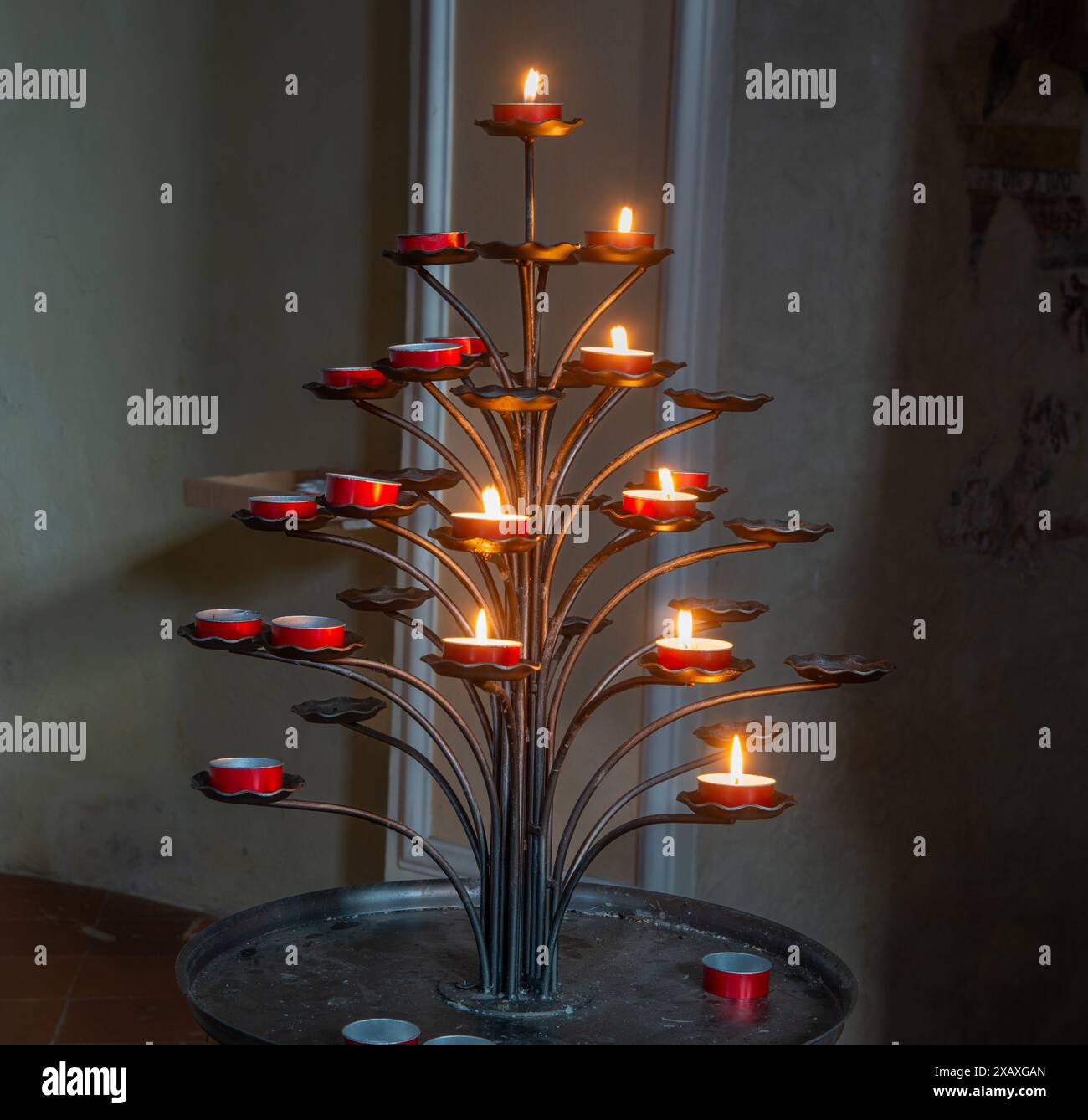 Antique wrought iron candelabra with lit candles Stock Photo - Alamy