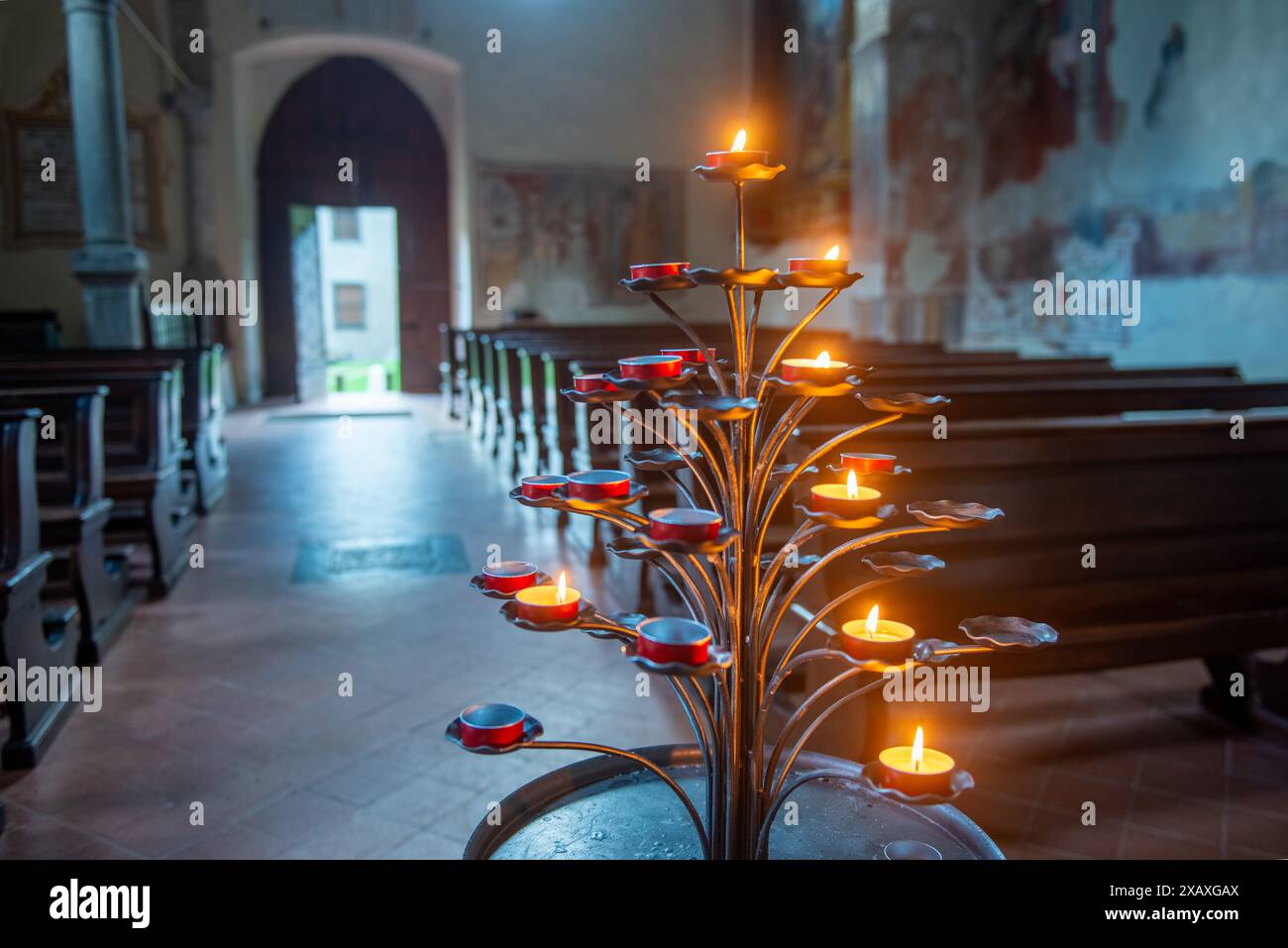 Antique wrought iron candelabra with lit candles Stock Photo - Alamy
