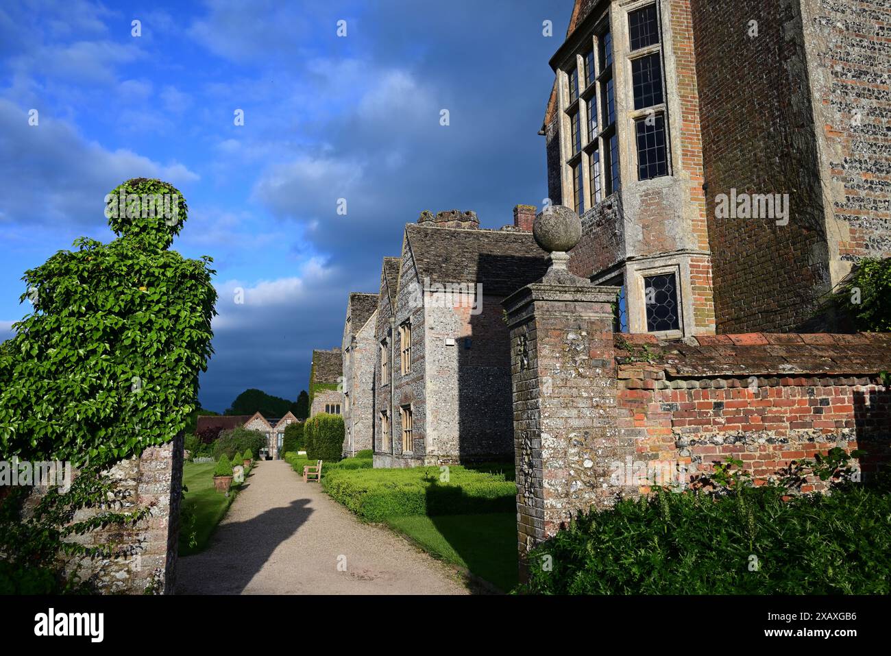 Late evening sunshine highlights the rear elevation of Littlecote House ...