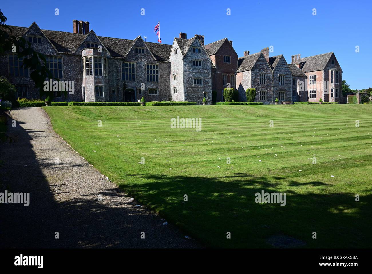 Early morning sunshine casts shadows across the lawn and rear elevation ...