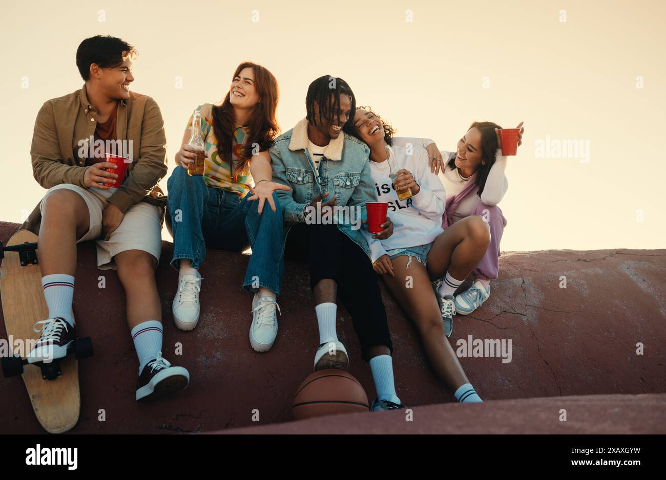 A group of friends hanging out, chatting and enjoying drinks outdoors ...