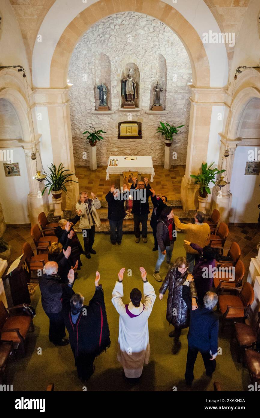 raised hands praying to God, mass celebration in Sant Honorat sanctuary ...
