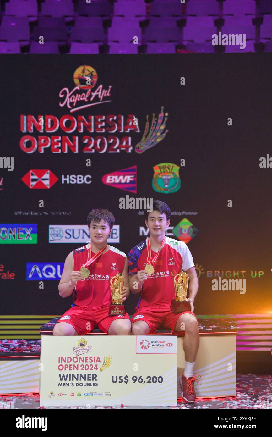 Jakarta, Indonesia. 9th June, 2024. Liang Weikeng (L)/Wang Chang pose for photos on the podium ...