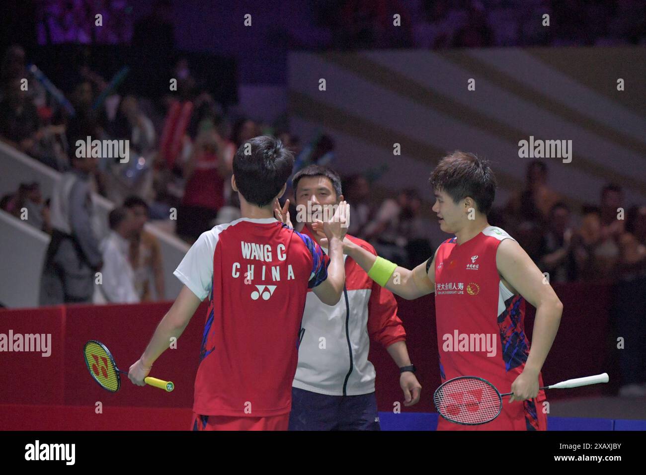 Jakarta, Indonesia. 9th June, 2024. Liang Weikeng(R)/Wang Chang(L) celebrate with their coach ...