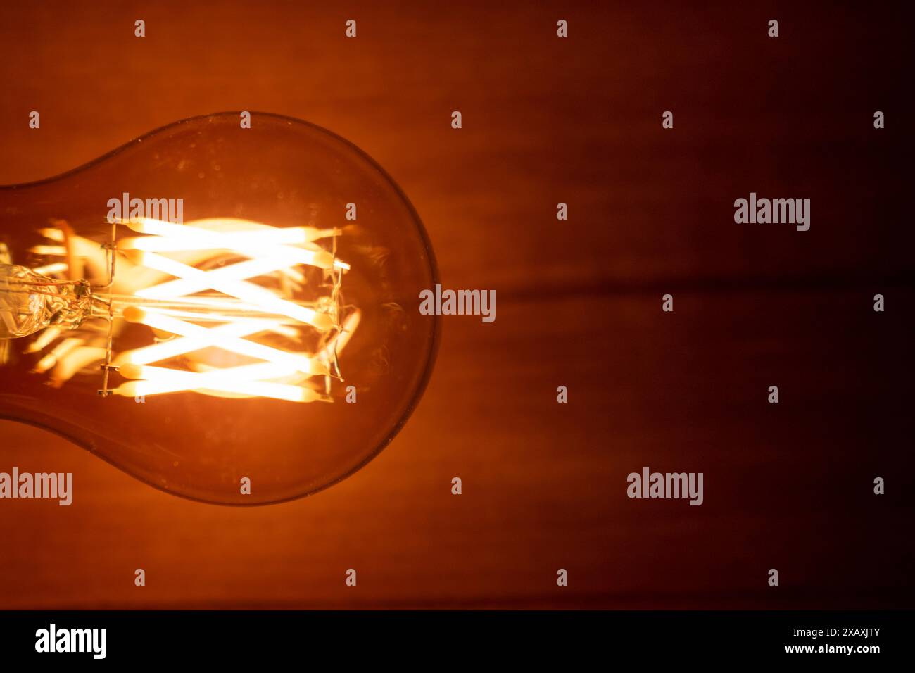 A60 E27 Edison light bulb, also known as filament light bulb on wooden ...