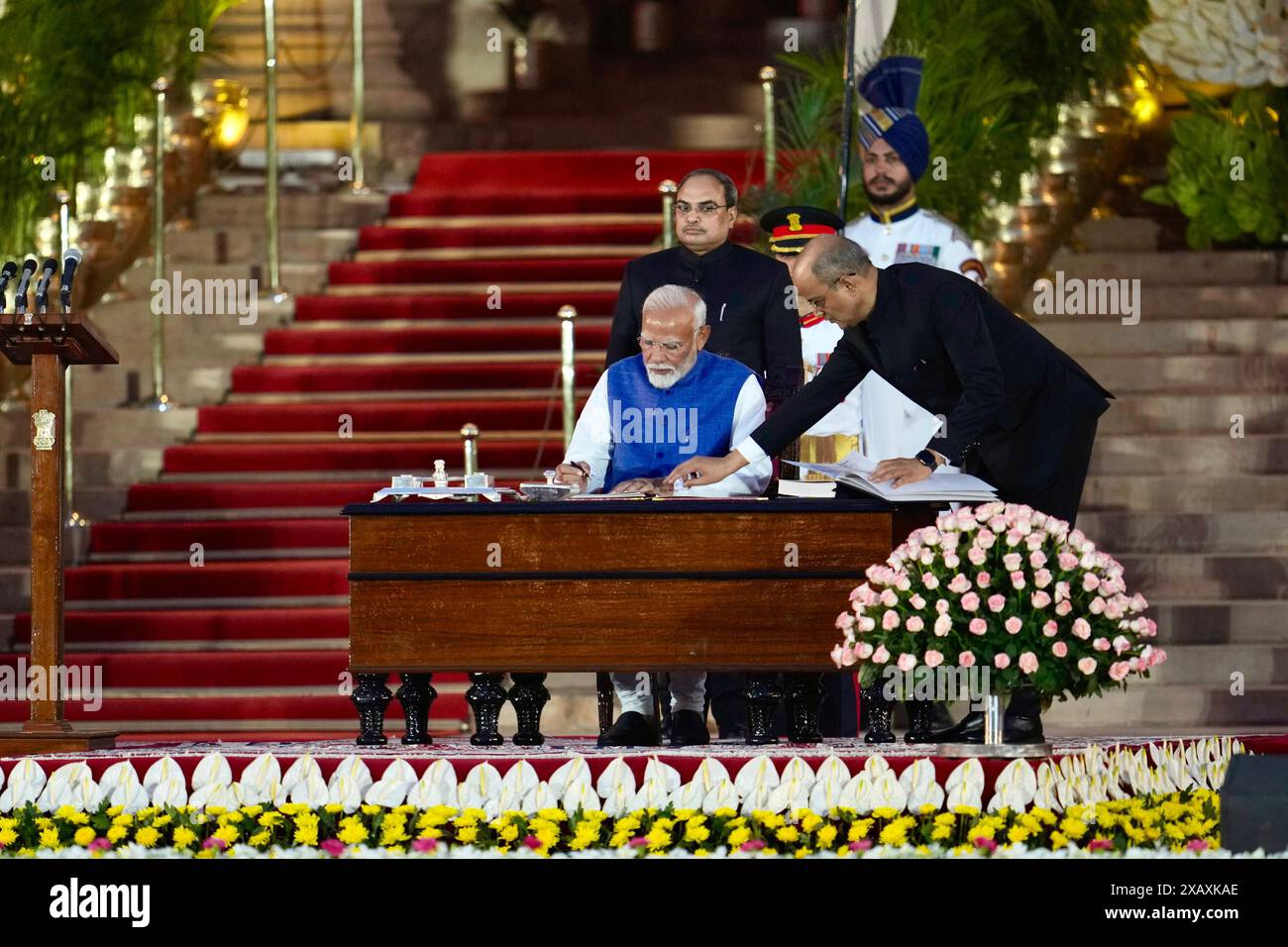 Narendra Modi, signs the book after taking oath as the Prime Minister ...