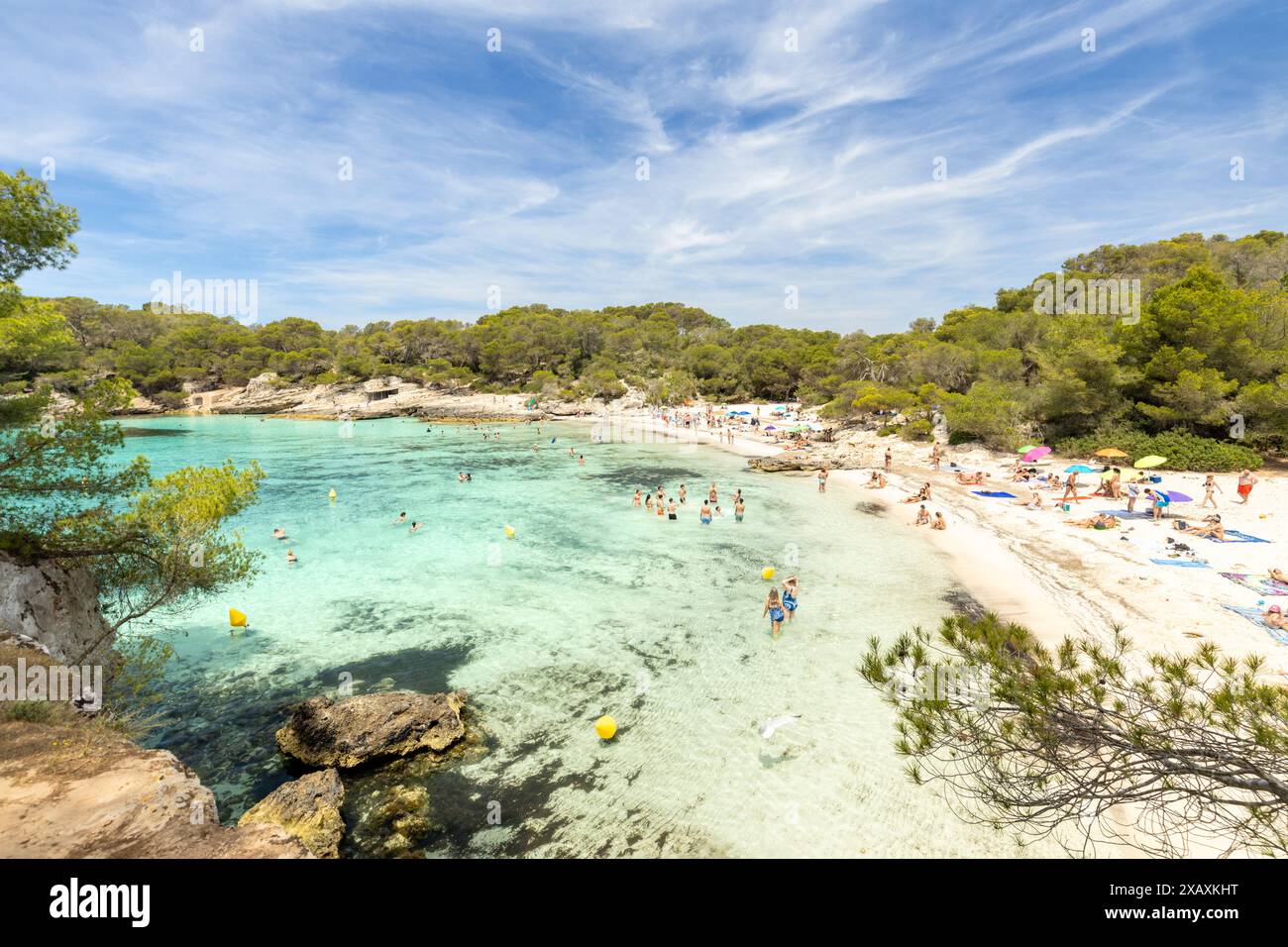 View of Turqueta beach, beautiful azure water, people sunbathing ...