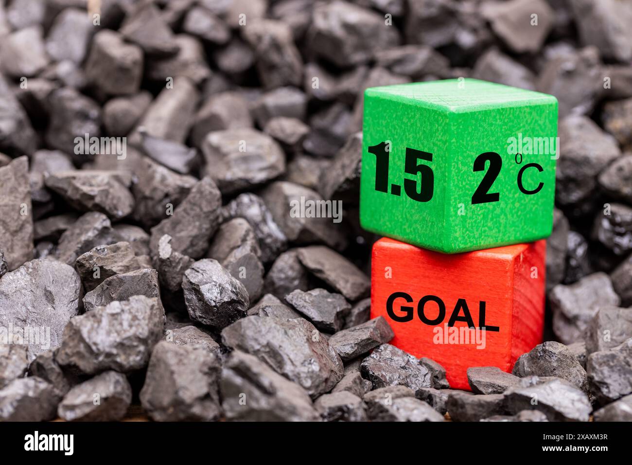 Symbol of reducing global warming among coal piles. A rotating wooden ...