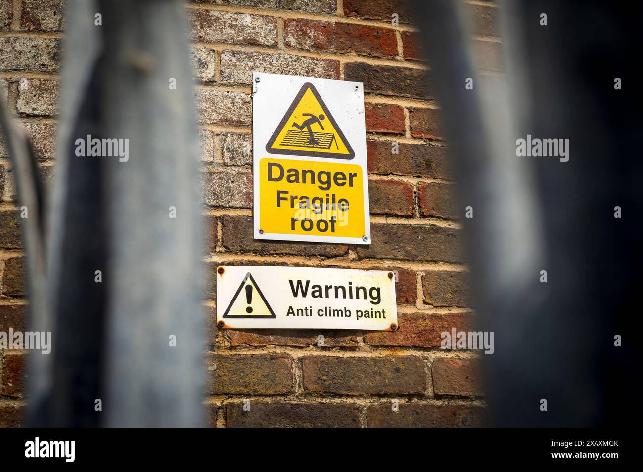 warning sign about anti climb paint and fragile roof on the side of a ...