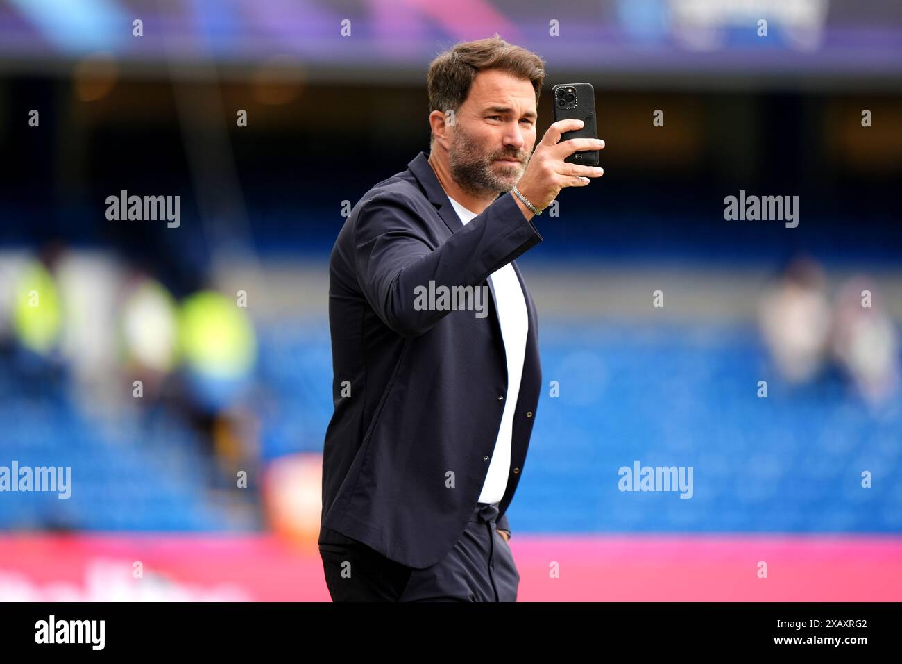 Eddie Hearn takes photographs before Soccer Aid for UNICEF 2024 at ...