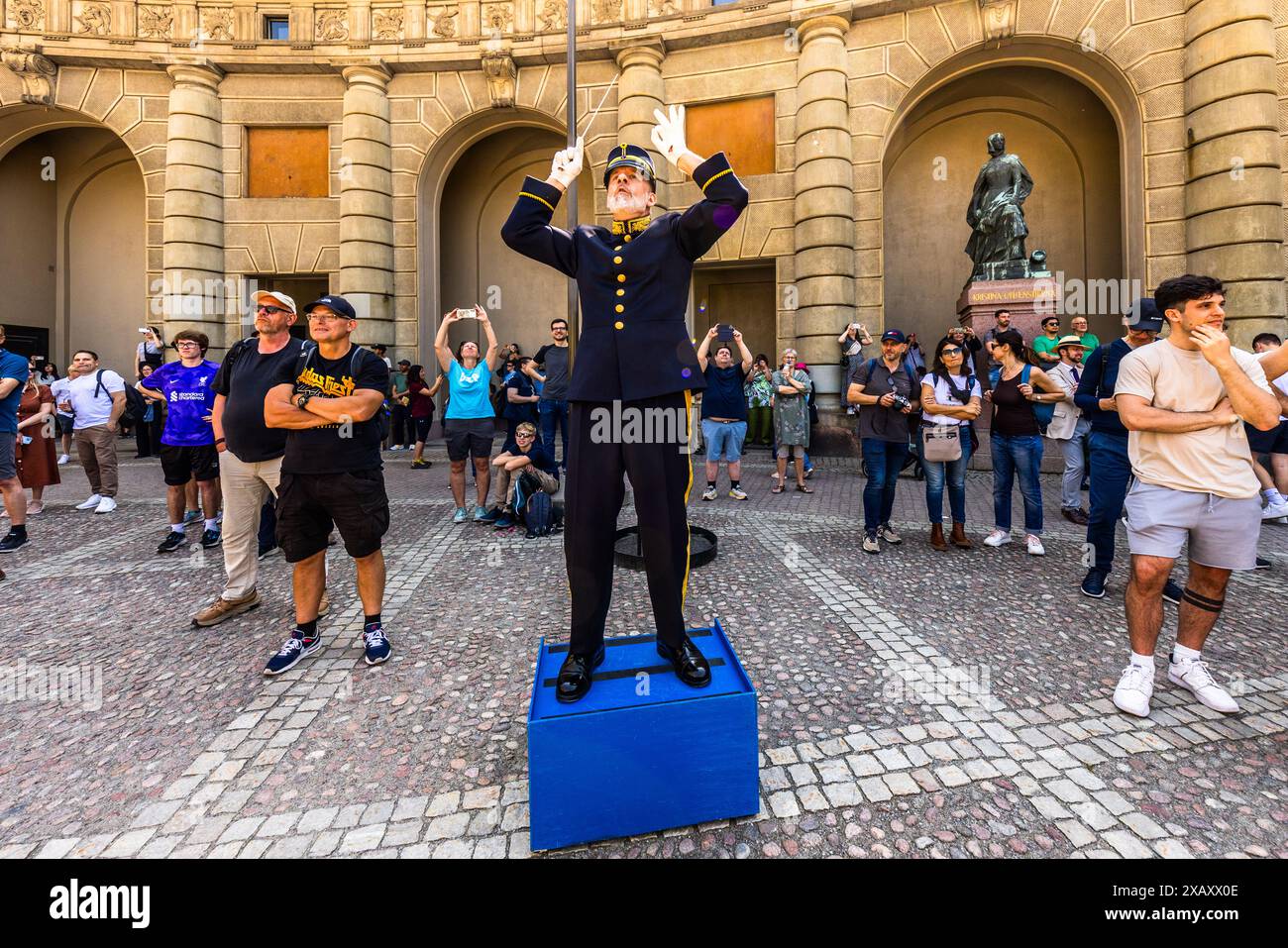 The conductor of the cavalry band stands on a platform in the middle of ...