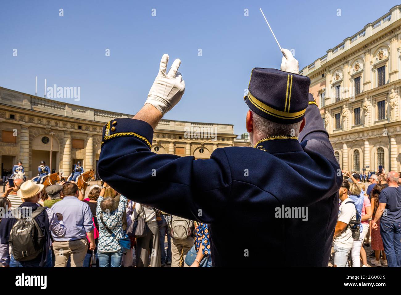 The conductor of the cavalry band stands on a platform in the middle of ...