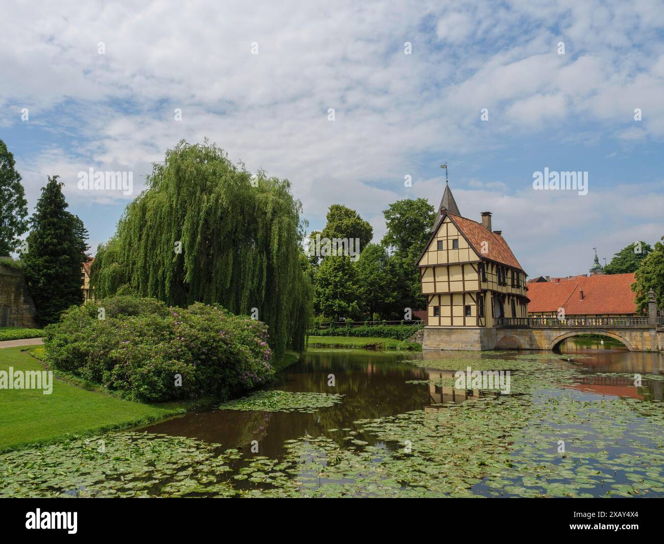 Castle with half-timbered architecture and red tiled roof, surrounded ...