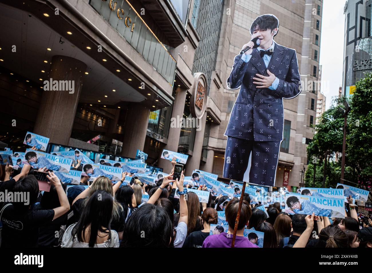 A fan holds up a cardboard cutout of pop idol Ian Chan in Times Square ...