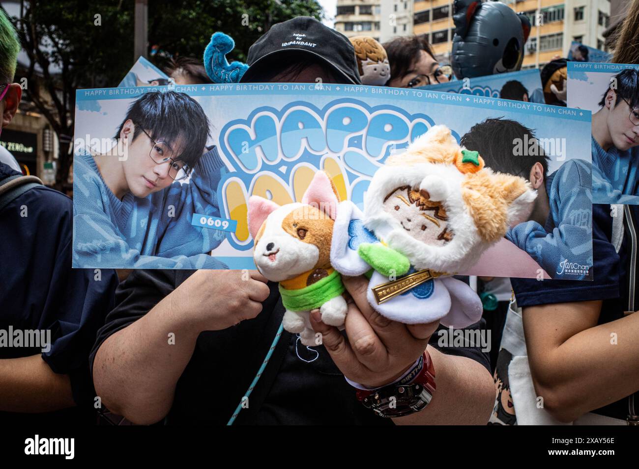 Hong Kong, China. 09th June, 2024. A fan holds up a sign and some ...