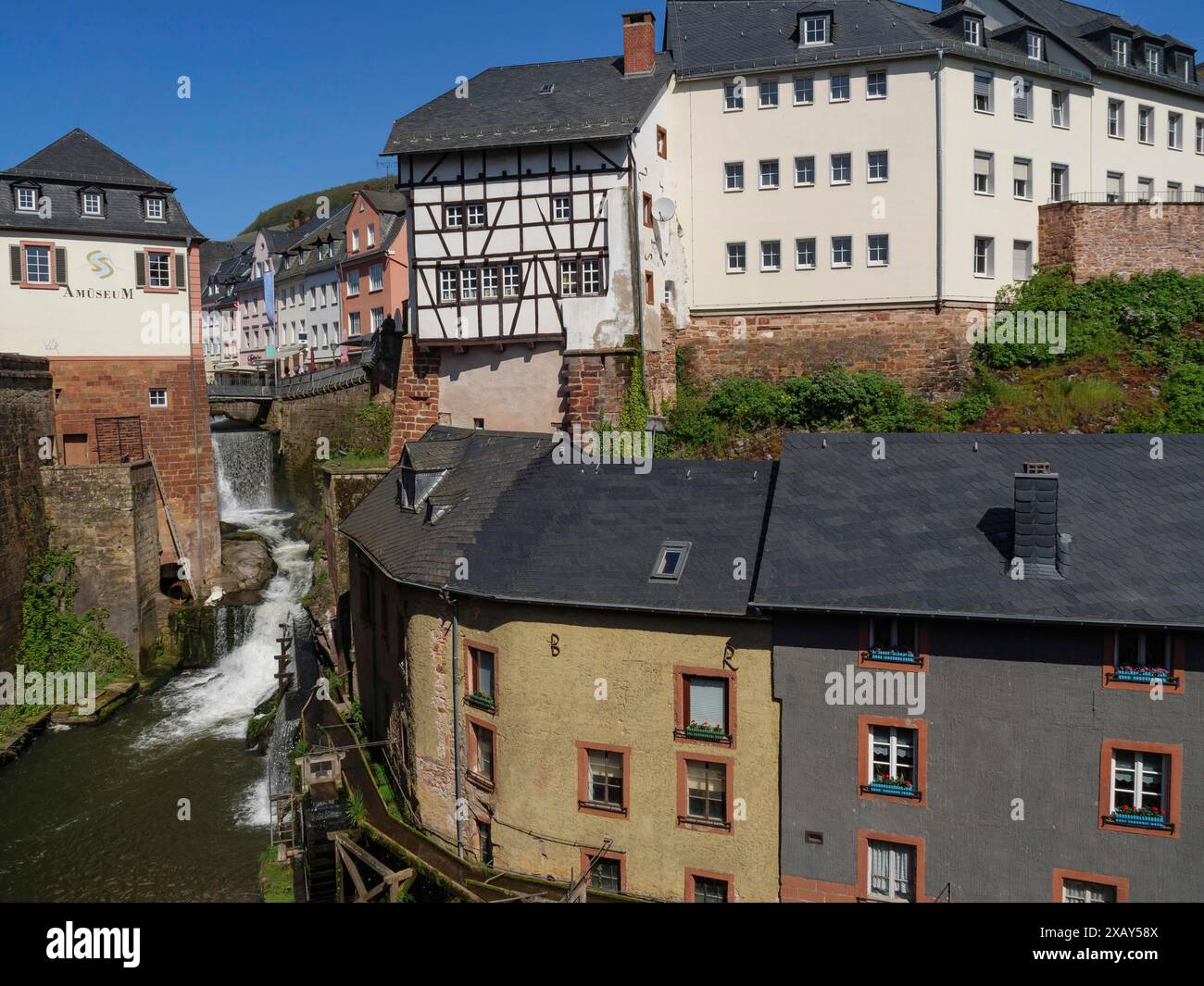 Historic old town with half-timbered houses, a small waterfall and a ...