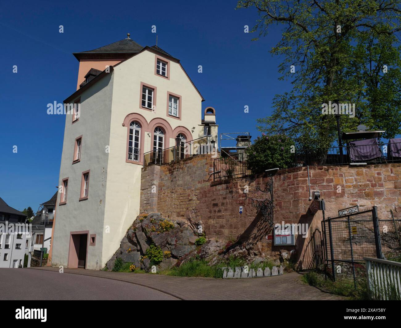 An old building with tower and stony surroundings under a clear blue ...
