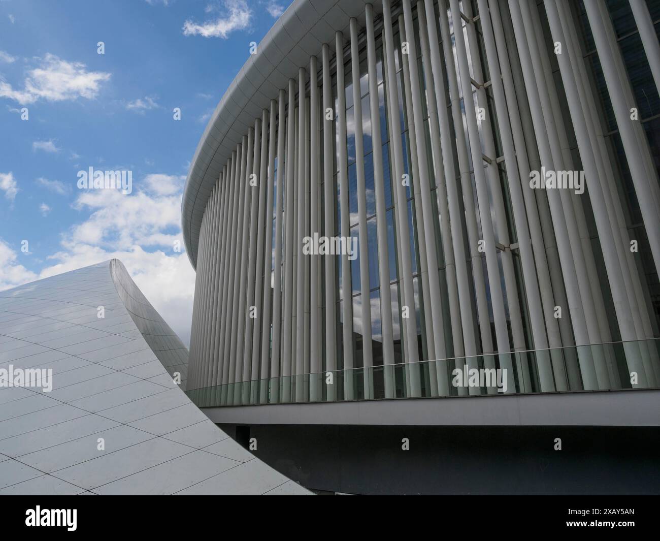 Modern architecture with columns and large glass surfaces that reflect ...