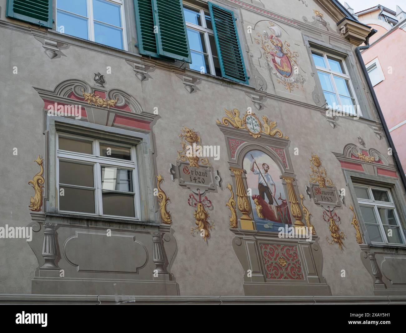 Detailed mural painting on a historic house facade with windows and ...