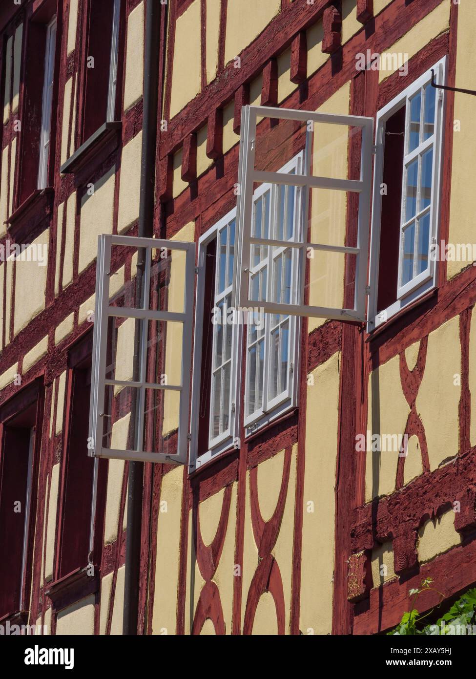 Close-up of a half-timbered house with open windows and visible details ...