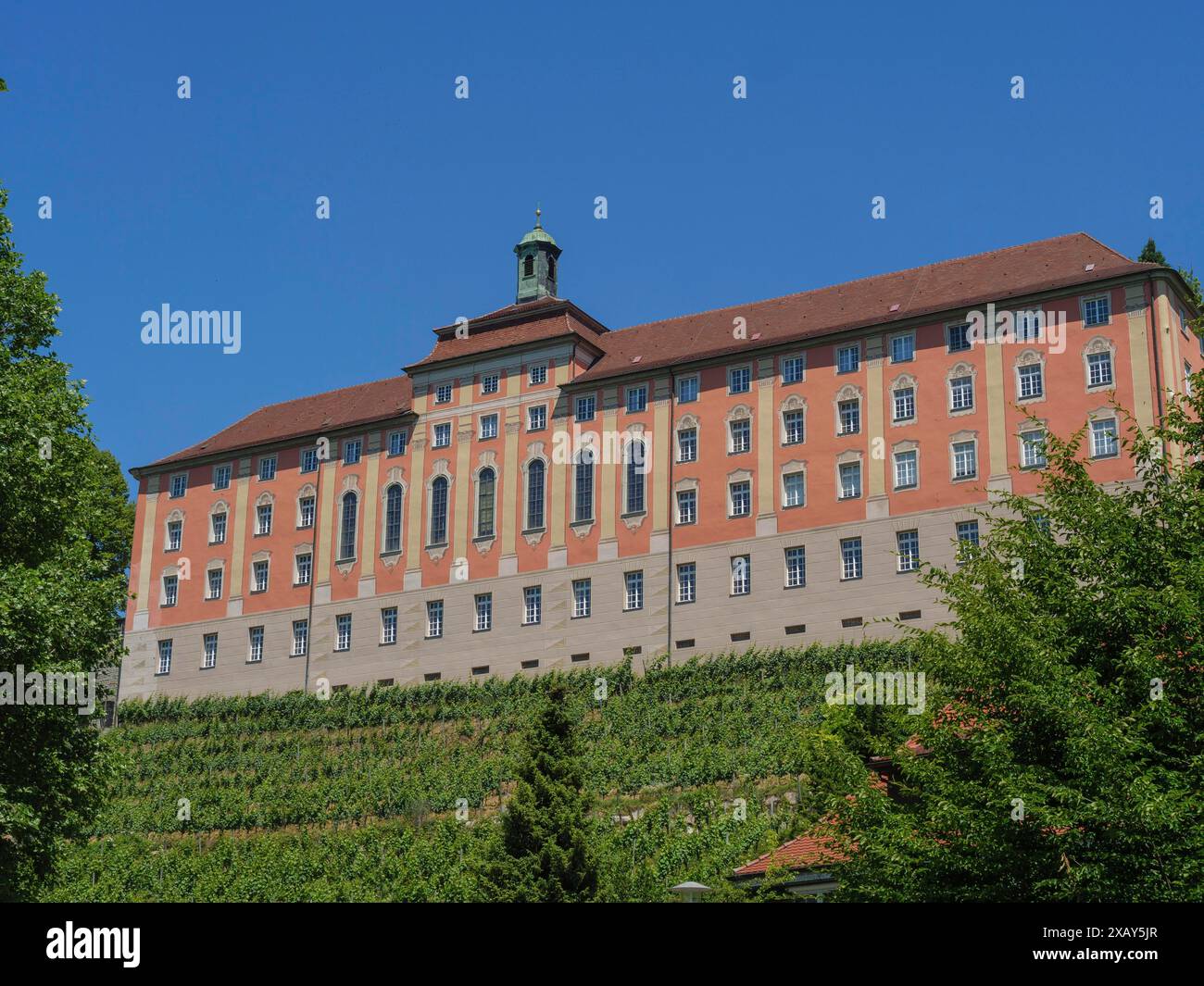 Large historic building with red roof tiles and many windows ...