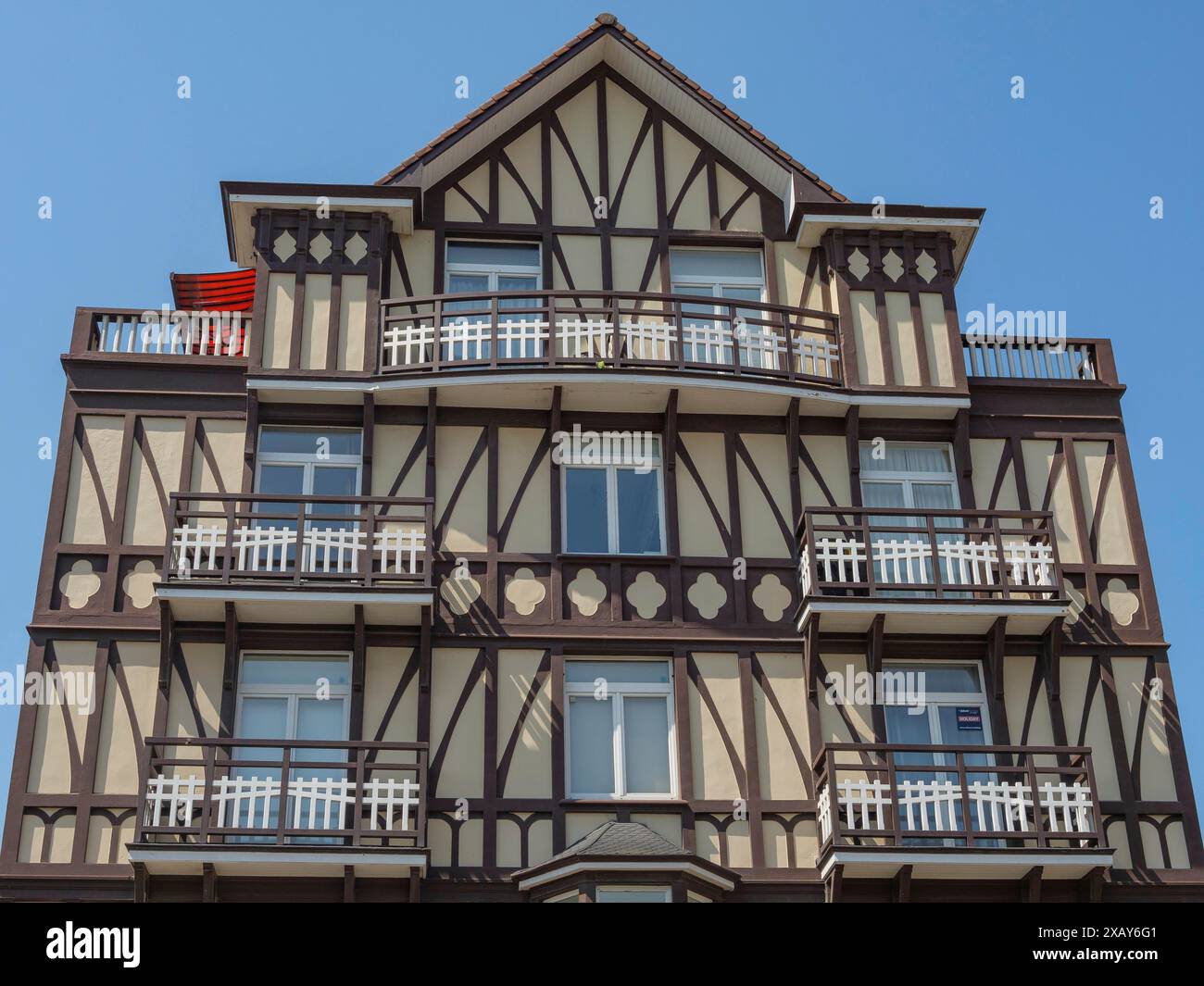 Facade of a multi-storey half-timbered house with balconies on a sunny ...