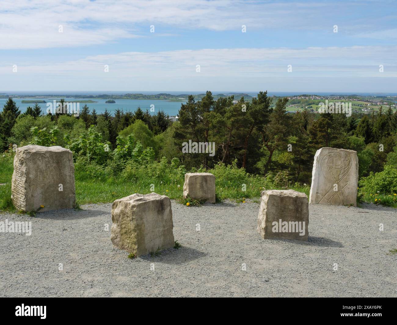 Stone monuments in a green landscape with a view of the sea and blue ...