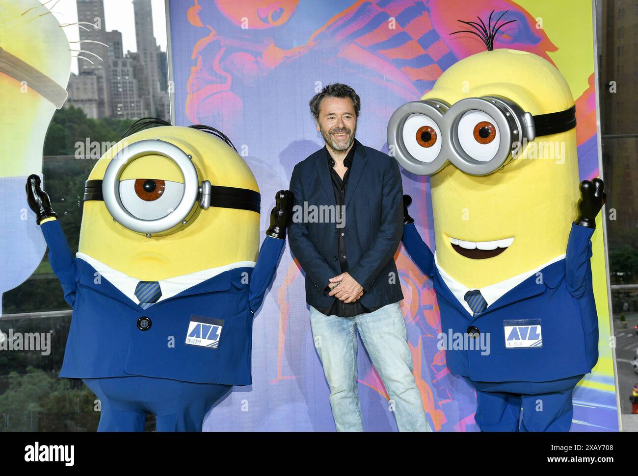 Co-director Patrick Delage poses with Minion characters at the premiere ...