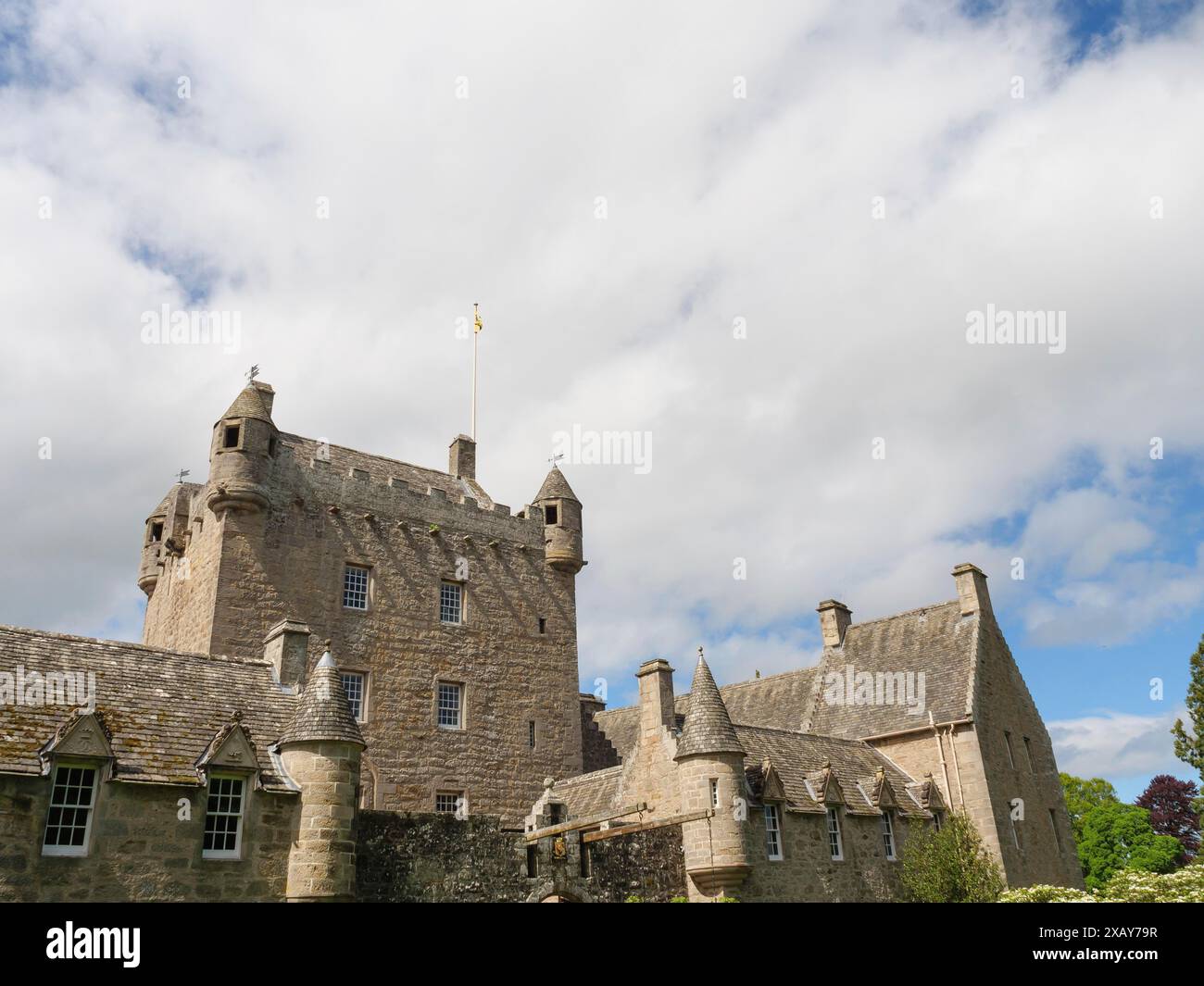 Large historic castle with towers and stone walls under a cloudy sky ...