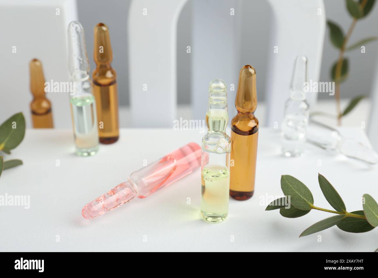 Stylish presentation of different skincare ampoules on white background ...