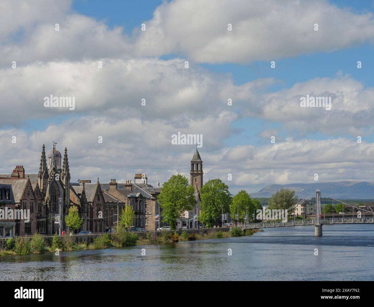 Historic buildings and a bridge over the river, surrounded by trees ...