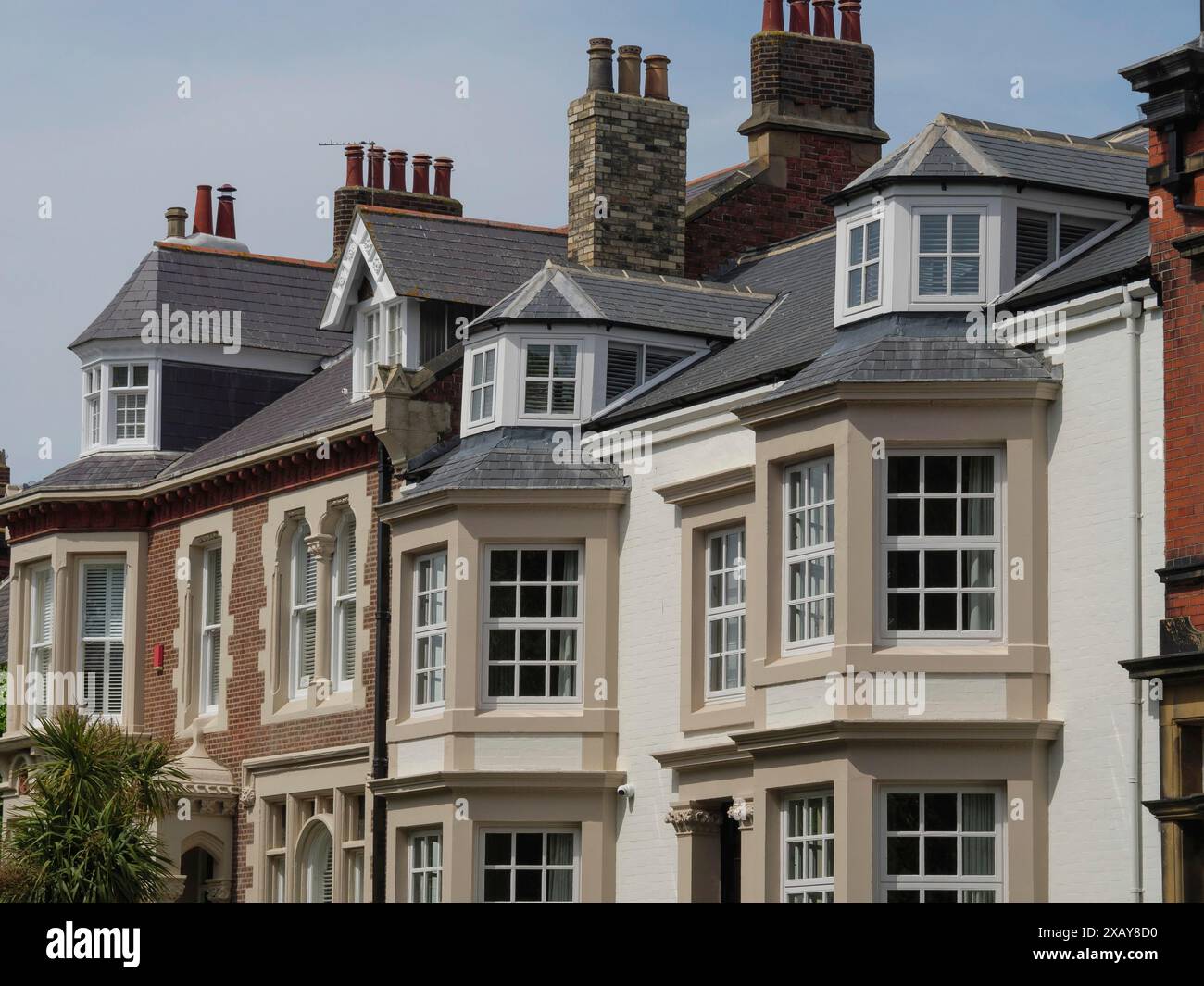 Terraced houses with large windows and tiled roofs in an urban ...