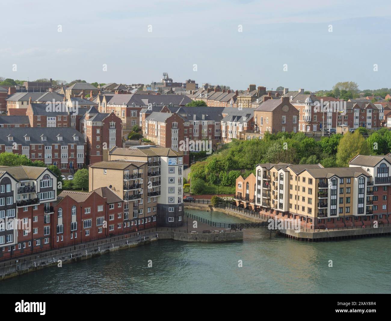 Residential building along a river with a view of the city, Newcastle ...