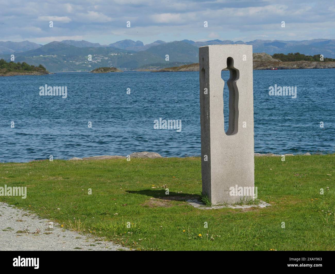 Concrete sculpture with a view of water and mountains, surrounded by ...