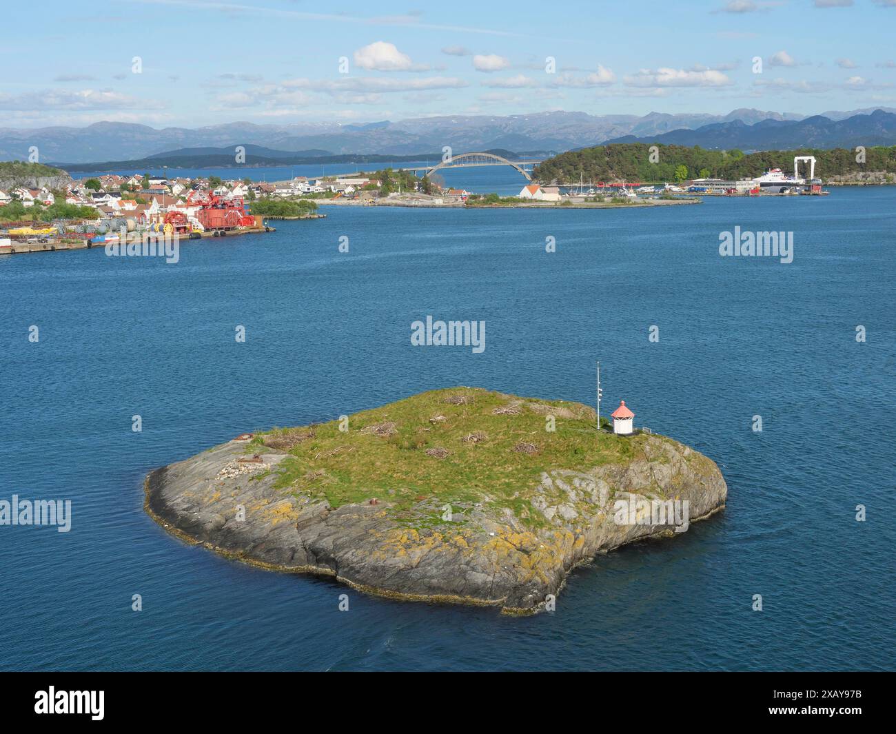 Small island with a lighthouse, surrounded by water and surrounded by ...