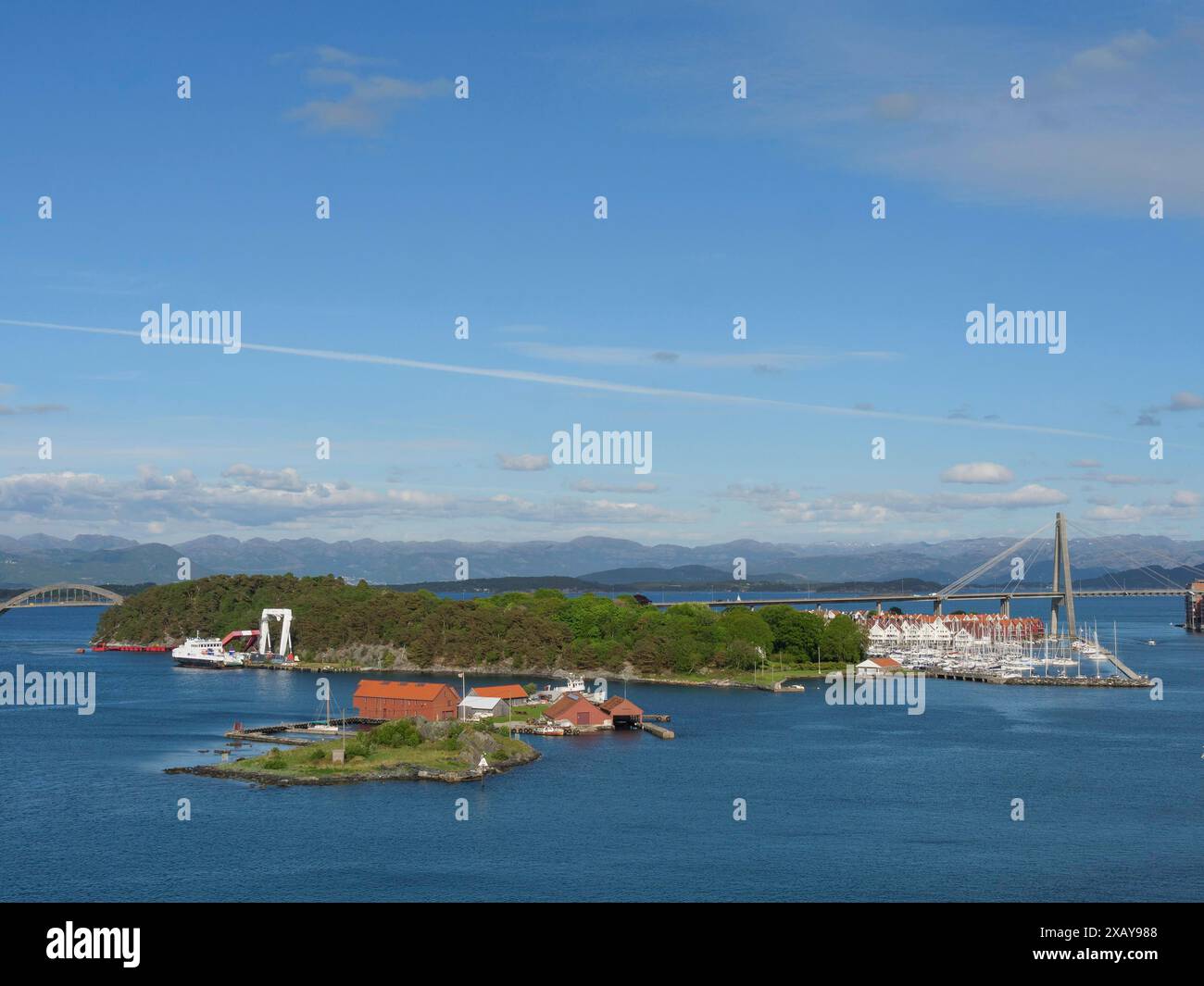 Coastal view with a small island, buildings in the harbour area and a ...