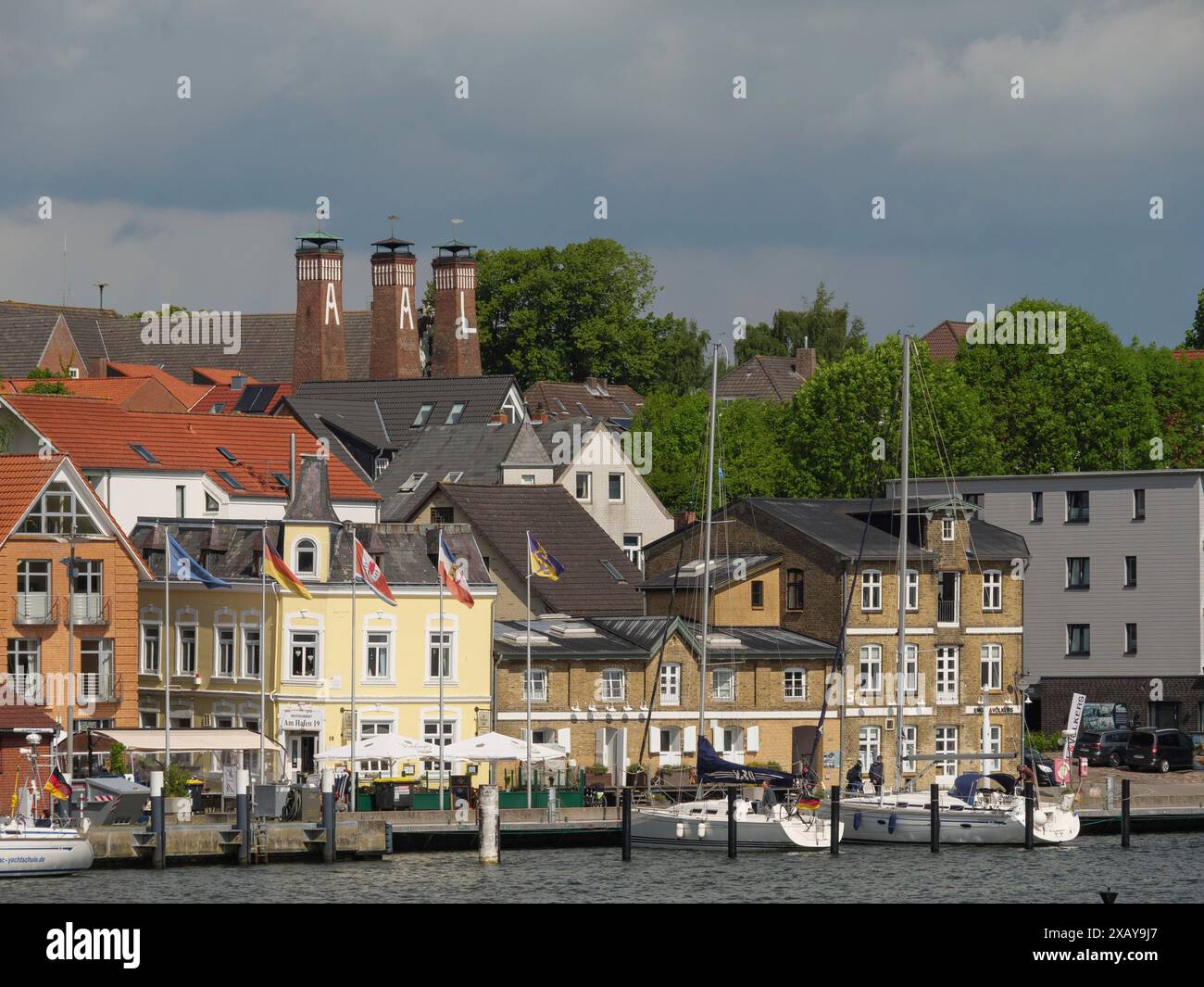 Town view with historic buildings, chimneys and boats on the waterfront ...