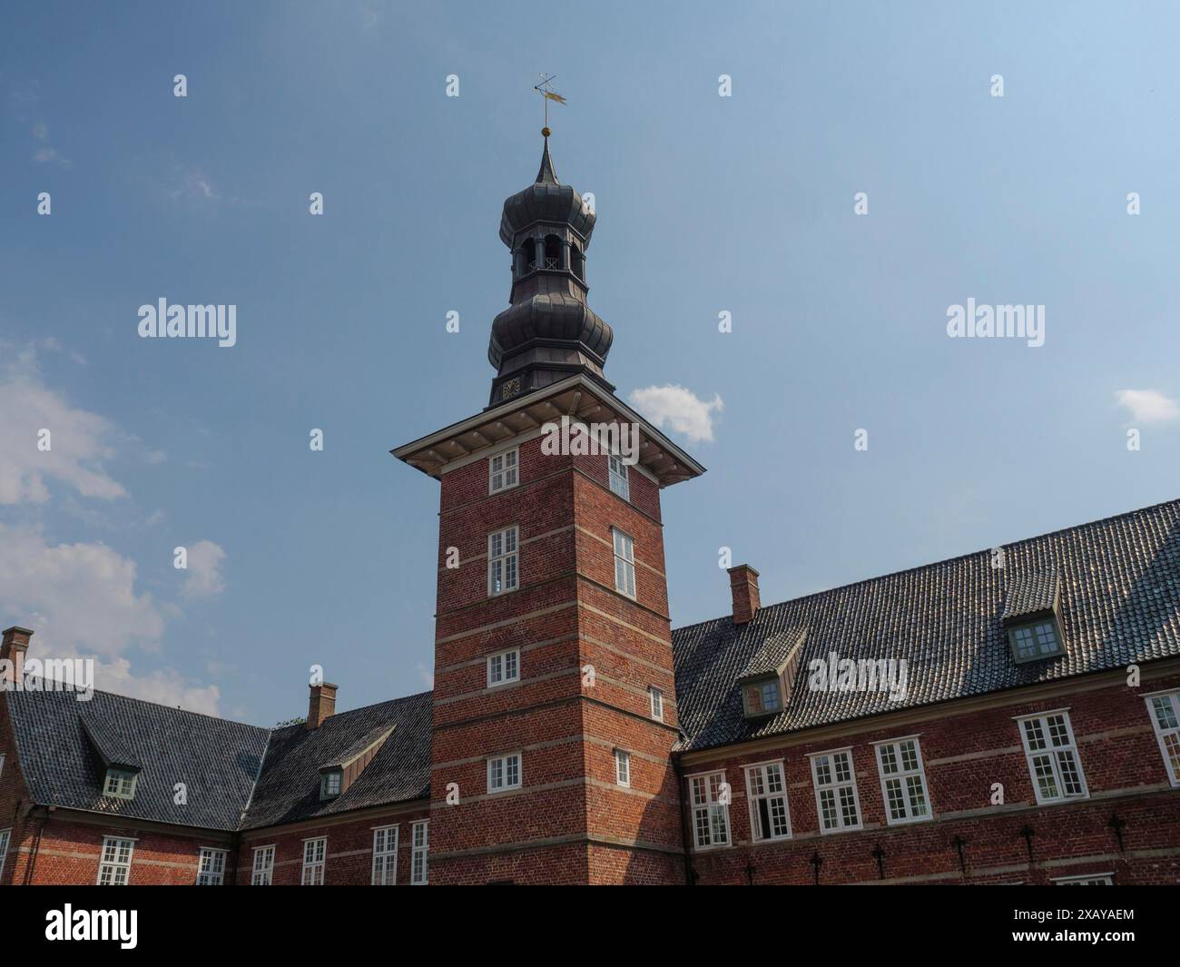 A historic building with a tall tower and several windows standing ...