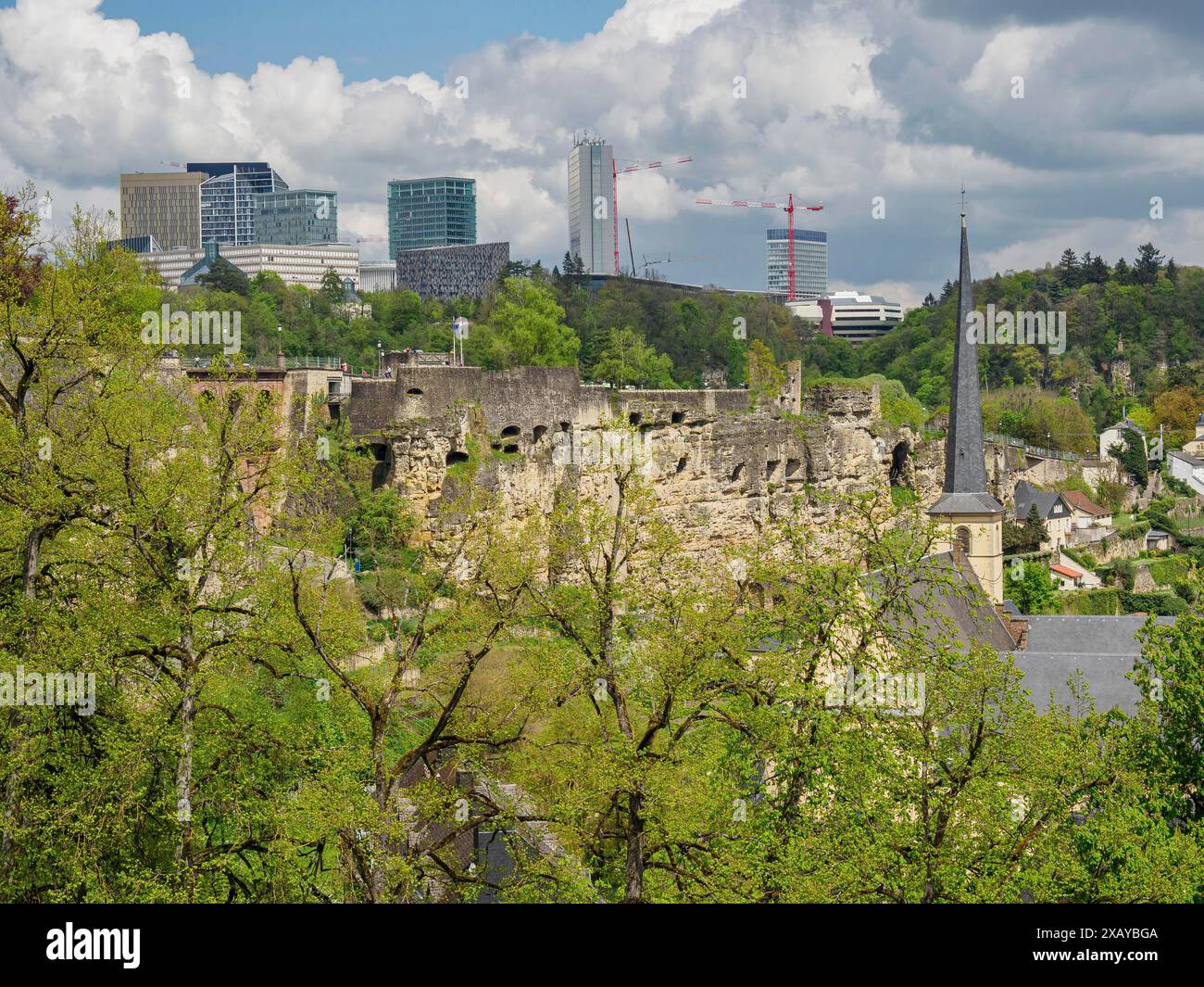 Ruins of a castle in front of a modern skyline with skyscrapers and ...