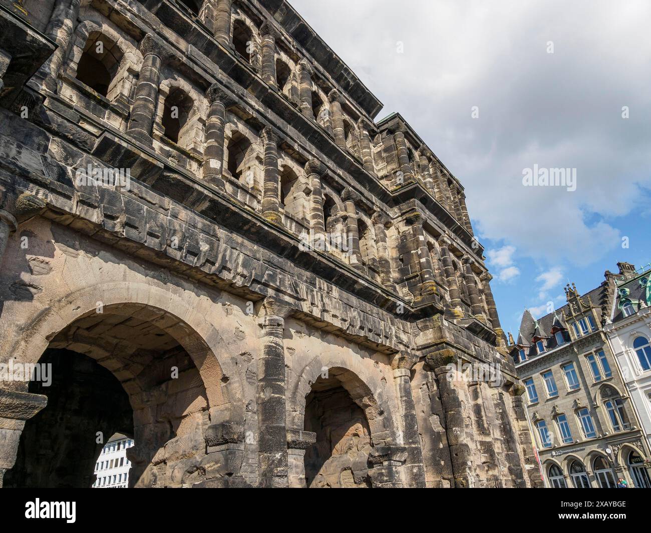 Old stone architecture under a blue sky with arches and a story, Trier ...