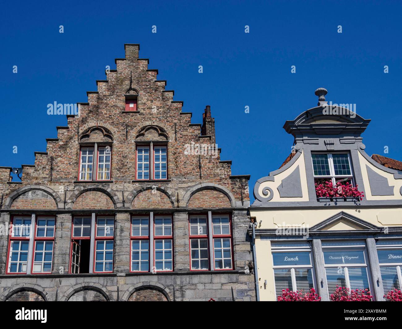 Two historic buildings with brick facades and windows, one grey and the ...