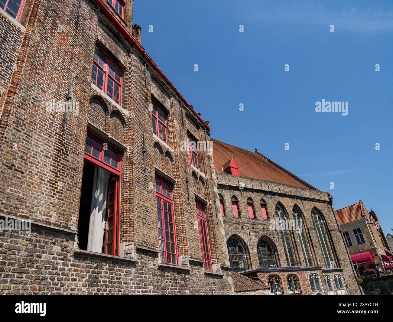 Historic brick architecture with a striking roof and large windows ...